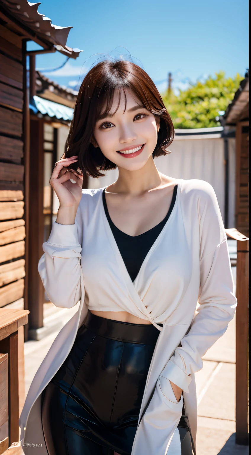 A woman in a white shirt and black leather pants posing for a picture ...