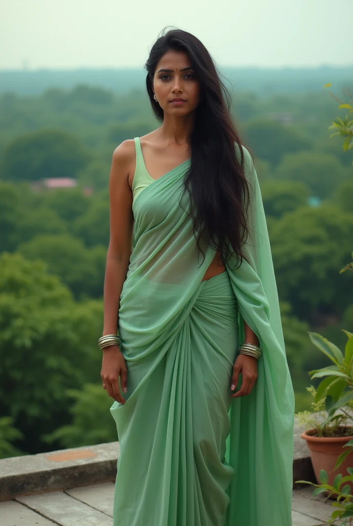 A women in Standing in rooftop.. Waring light green colour sharee ...