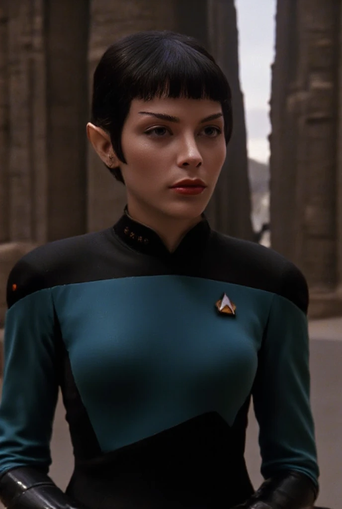 An vulcan woman T'Lyn with short hair stands in the ancient temple ...