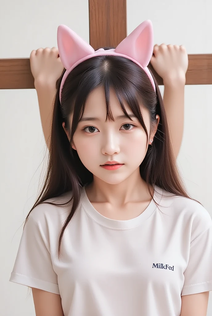 A Japanese woman wearing a MilkFed logo t-shirt, restraining her hands ...